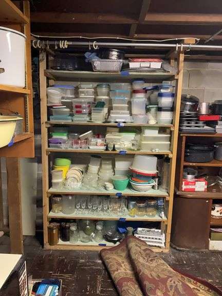 Contents of shelf unit: Tupperware, plasticware, stemware, storage jars ...