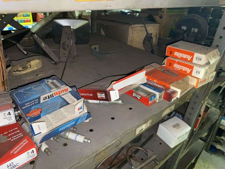 Shelf of automotive parts to include: Champion, AC-Delco, and Autolite ...