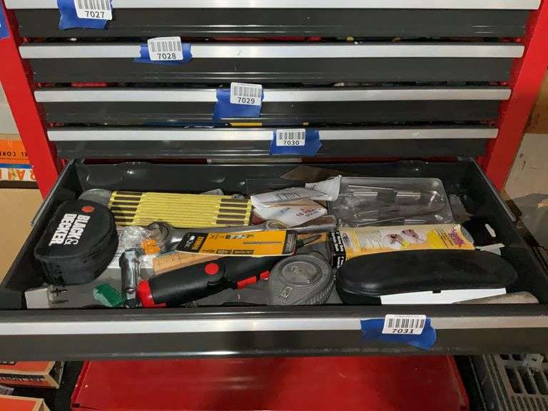 Contents of drawer: carpenter's rule, chalk line, assorted tools ...