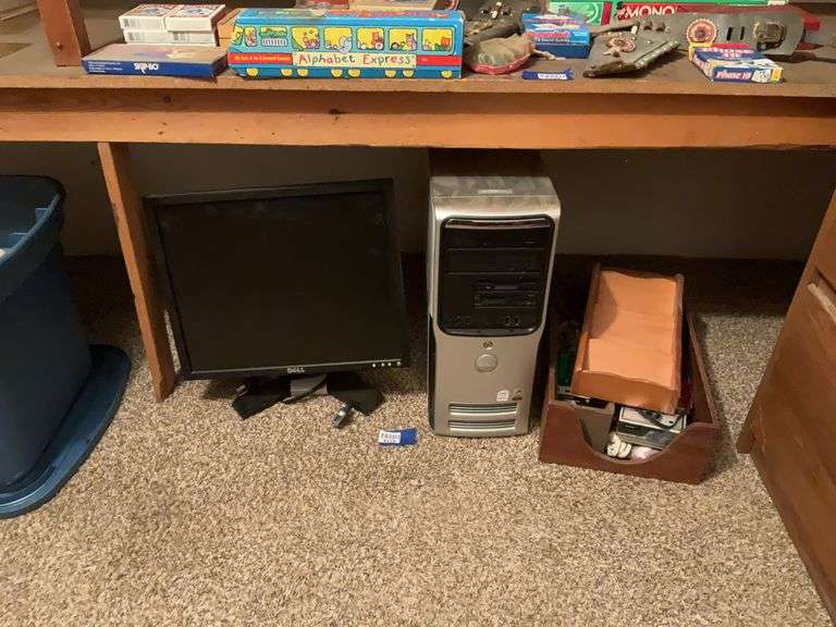 Dell computer tower and monitor, camera, extension cords, calculator ...