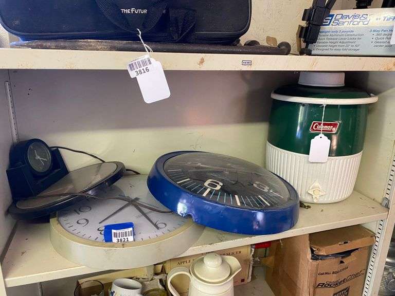 Contents of shelf: desk clock, wall clocks, Coleman picnic jug - Hurley ...