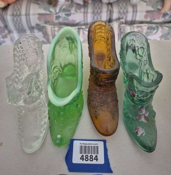 Four glass shoes including: green opalescent, amber Daisy & Button ...