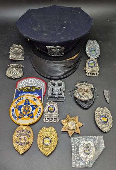 (W) Police badges and damaged hat. - Kraft Auction Service, LLC