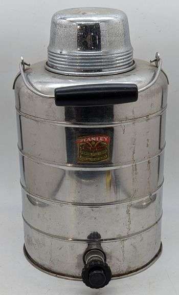 (A) Stanley stainless steel beverage dispenser. 14" tall and 9" wide ...