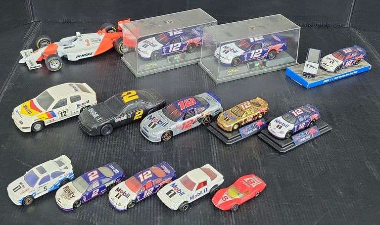 Various Mobil 1 Race Cars Including A Mercedes Benz Indy Car, Ford ...