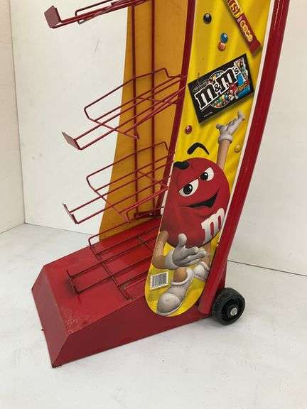 61” tall M&M merchandise tower on wheels - Key City Online Auctions Inc.