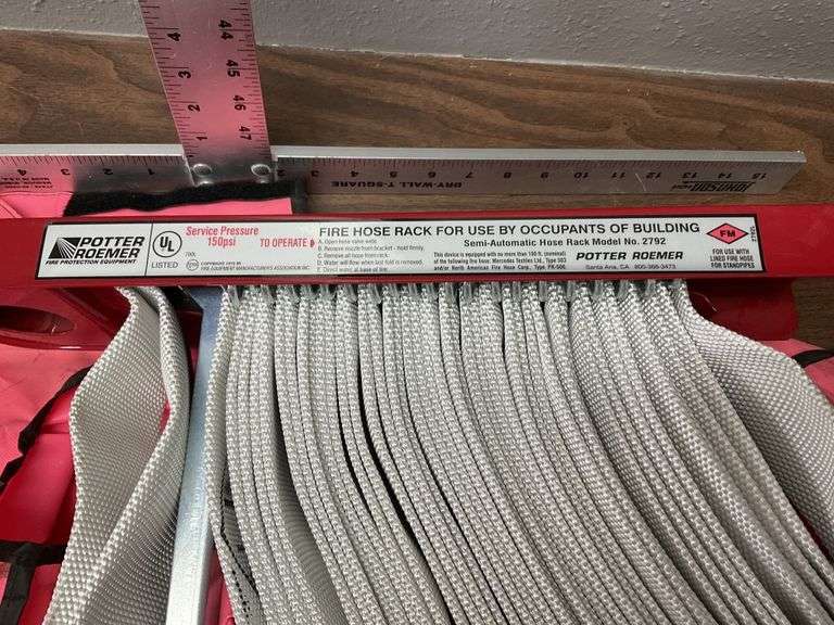 Fire Hose rack with hose and nozzle and bag - Legacy Auction Company