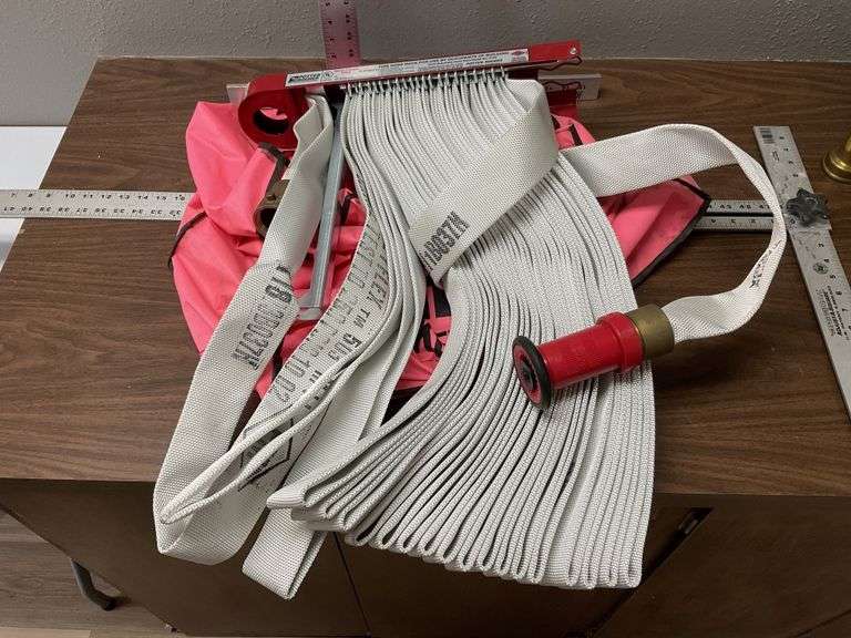 Fire Hose rack with hose and nozzle and bag - Legacy Auction Company