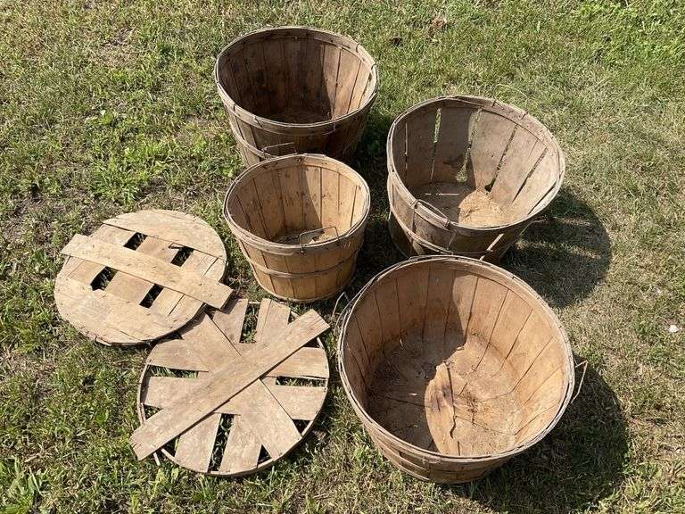 Four wooden bushel baskets - Legacy Auction Company