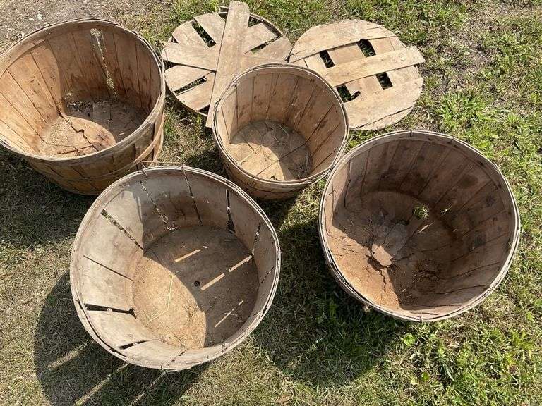 Four wooden bushel baskets - Legacy Auction Company