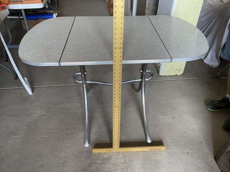 Drop leaf Formica top kitchen table. 48" x 30 - Legacy Auction Company