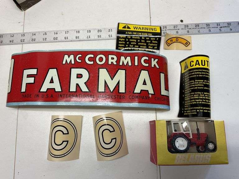 Farmall decals, and toy tractor - Legacy Auction Company