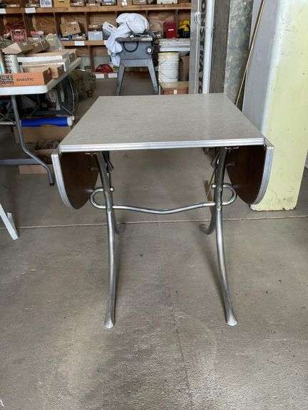 Drop leaf Formica top kitchen table. 48" x 30 - Legacy Auction Company