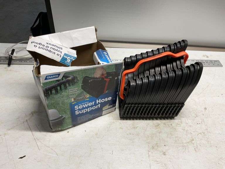 Side winder sewer hose support system - Legacy Auction Company
