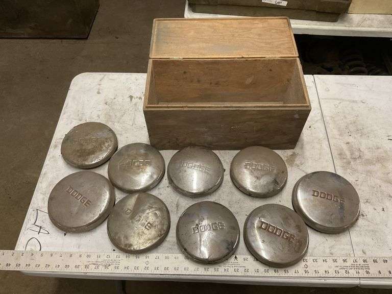 Vintage Dodge center caps and wooden box - Legacy Auction Company