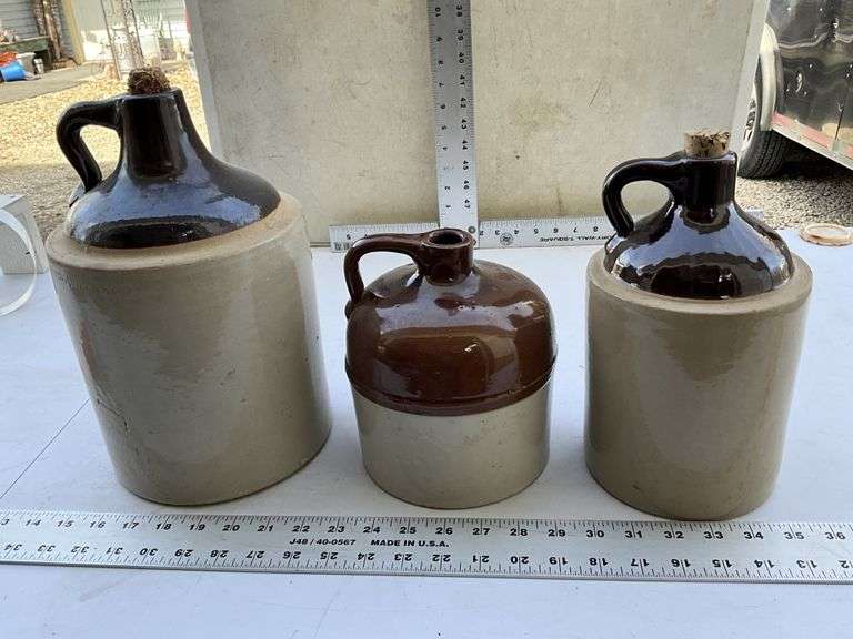 Stoneware jugs, chip on bottom of largest jug - Legacy Auction Company