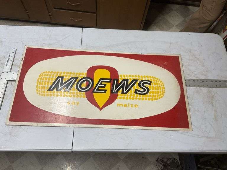 Moews Seed corn sign. Pressed board - Legacy Auction Company