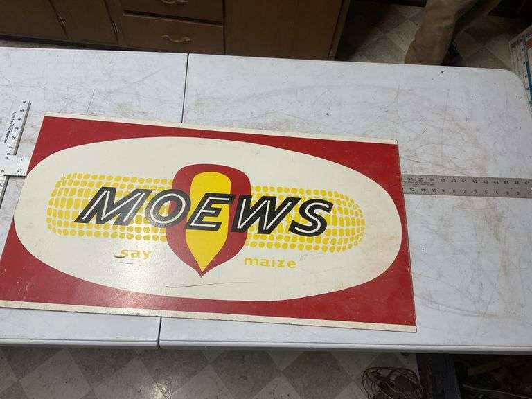 Moews Seed corn sign. Pressed board - Legacy Auction Company