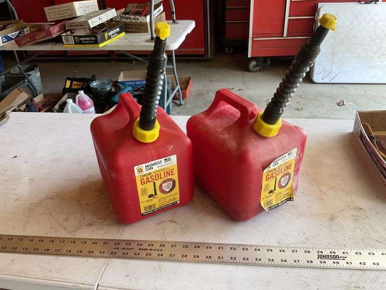 2- gas cans, small amount of mixed gas - Legacy Auction Company