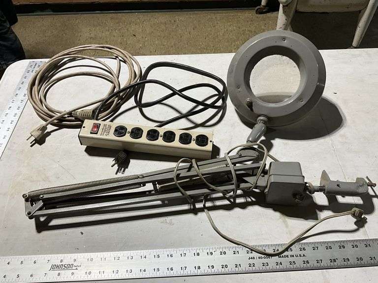 Magnifying light, power strip, cord - Legacy Auction Company