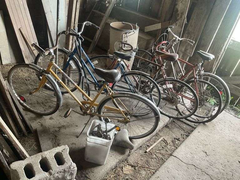 5- bikes and bucket with bike parts - Legacy Auction Company