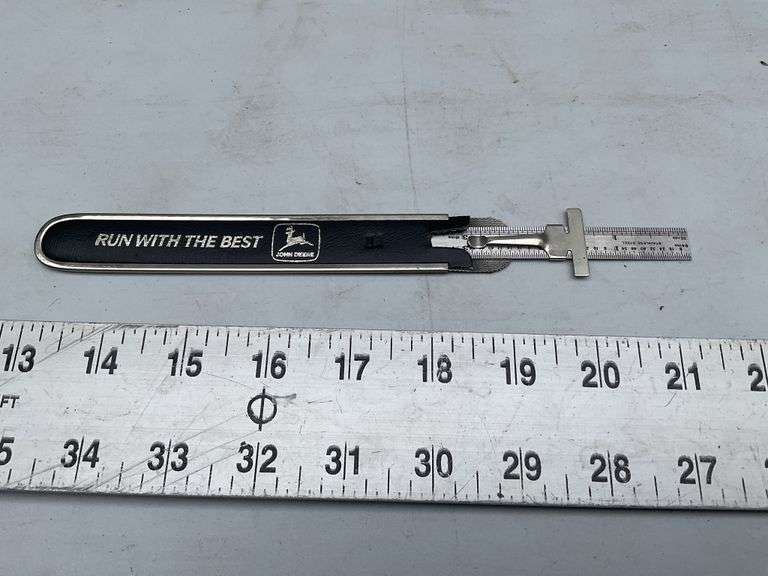 John Deere measuring device - Legacy Auction Company
