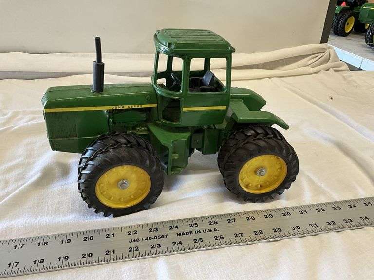 John Deere four-wheel-drive tractor - Legacy Auction Company