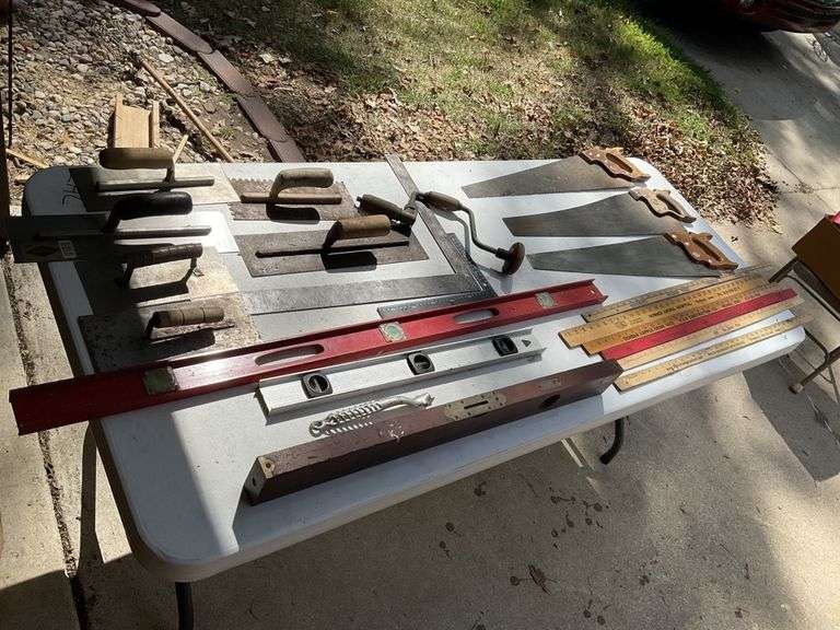 Masonry tools, levels, measuring sticks and saws - Legacy Auction Company