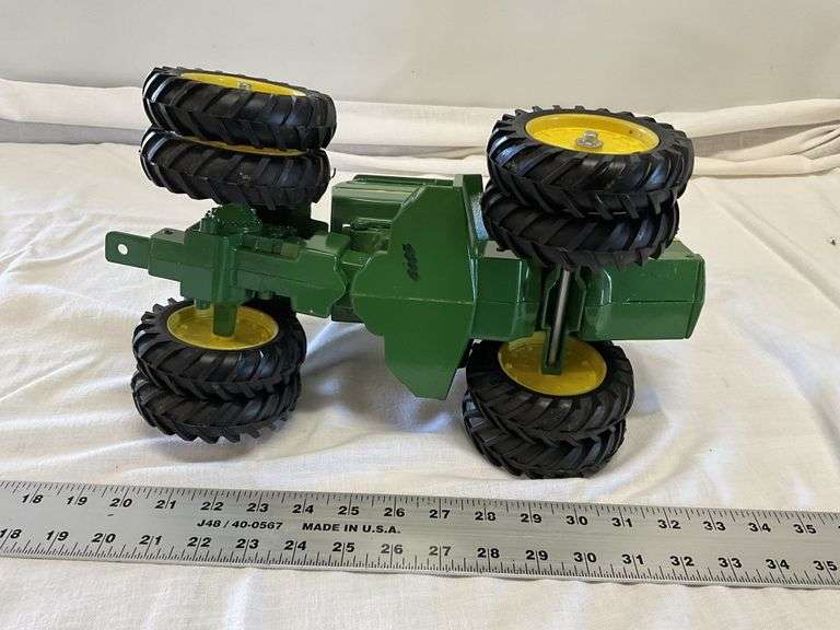 John Deere four-wheel-drive tractor - Legacy Auction Company