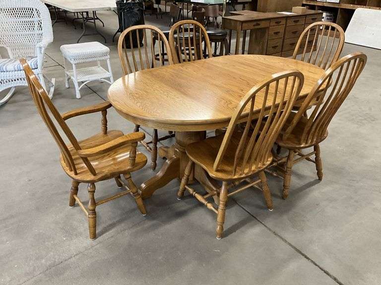 Amish made oak table with six chairs. Two swivel - Legacy Auction Company