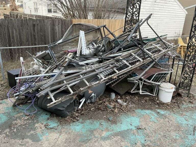 Scrap metal pile, porch posts/railing not - Legacy Auction Company