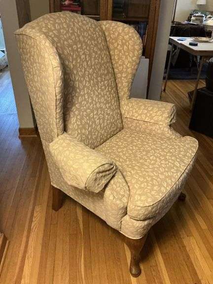 Beige wingback chair - Legacy Auction Company