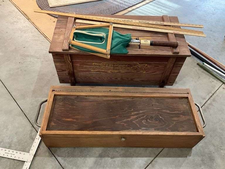 Empty wooden boxes, yardsticks, and tennis racket - Legacy Auction Company