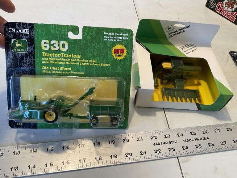 John Deere 630 tractor and picker and John Deere - Legacy Auction Company