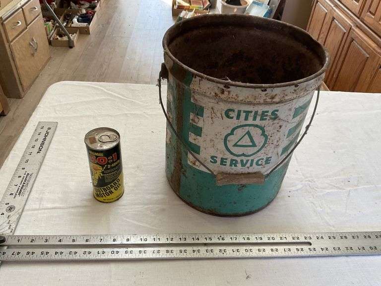 Cities Service vintage bucket and outboard motor - Legacy Auction Company