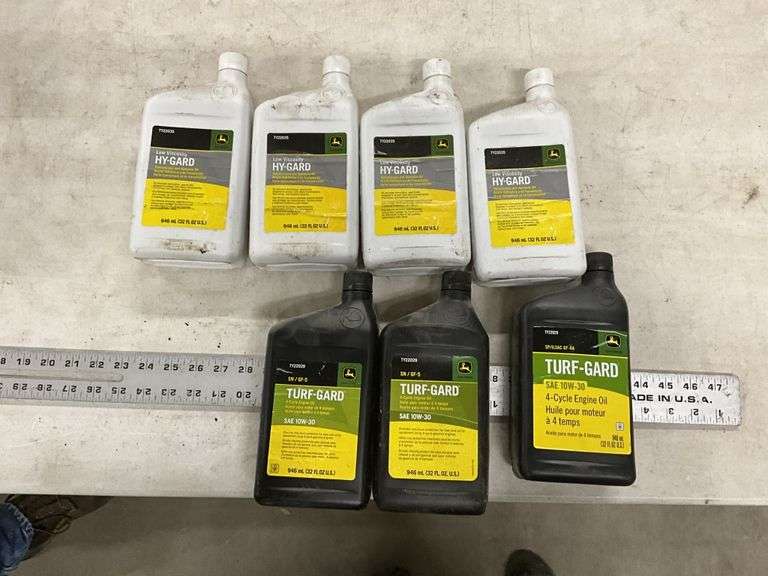 John Deere high guard, turf guard oil. All full - Legacy Auction Company