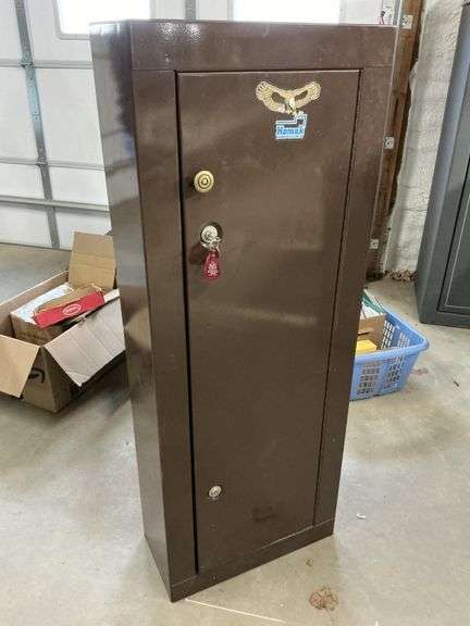 Homak metal 8- gun cabinet with keys, 21” x 55” x - Legacy Auction Company