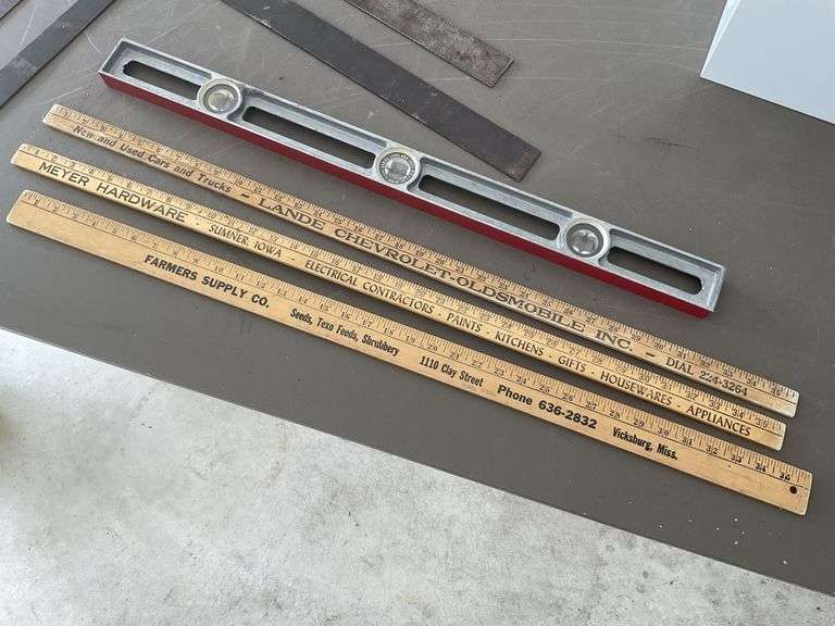 Advertising measuring sticks, level and squares - Legacy Auction Company