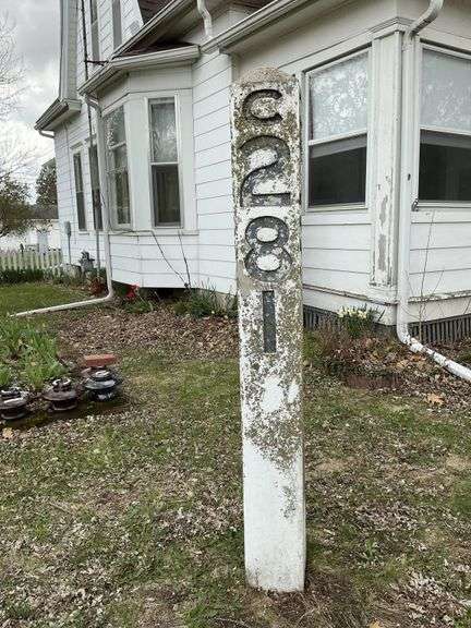 68" above ground concrete railroad marker. Buyer - Legacy Auction Company