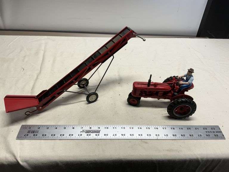 Farmall H toy tractor with man & metal elevator - Legacy Auction Company