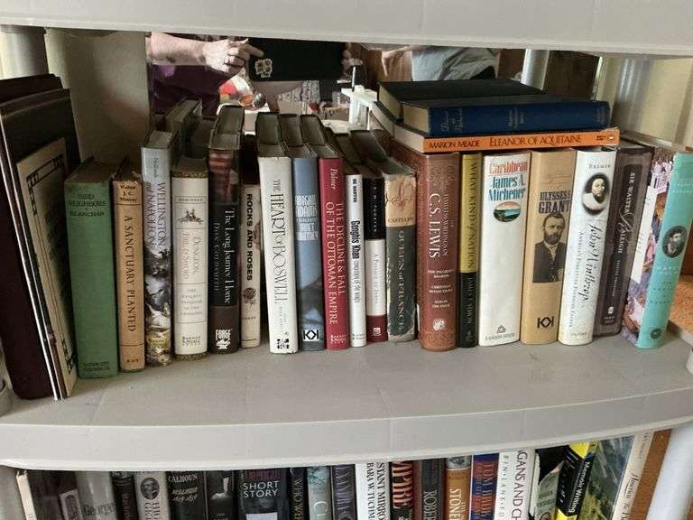 Plastic shelf with books-bring boxes - Legacy Auction Company