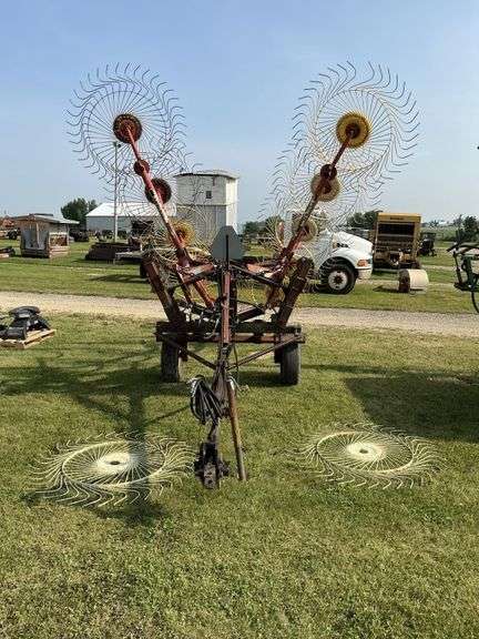 Gehl 10 wheel hay rake on homemade carrier - Legacy Auction Company