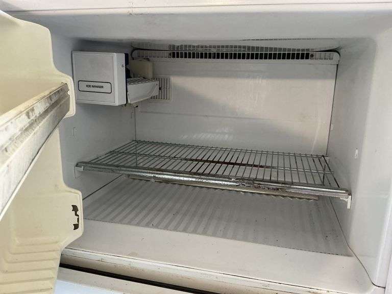 General Electric refrigerator/freezer-has been in - Legacy Auction Company