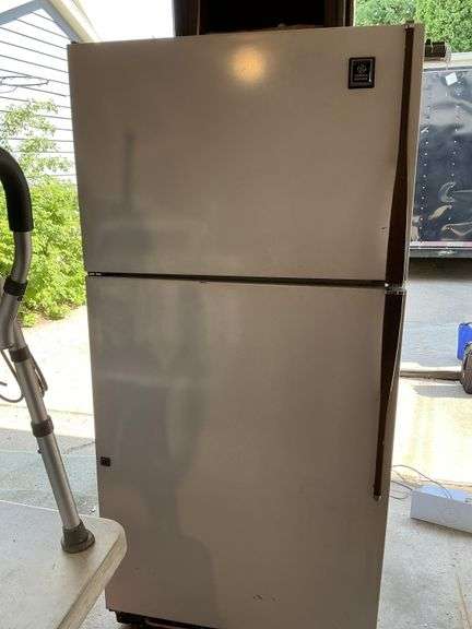 General Electric refrigerator/freezer-has been in - Legacy Auction Company