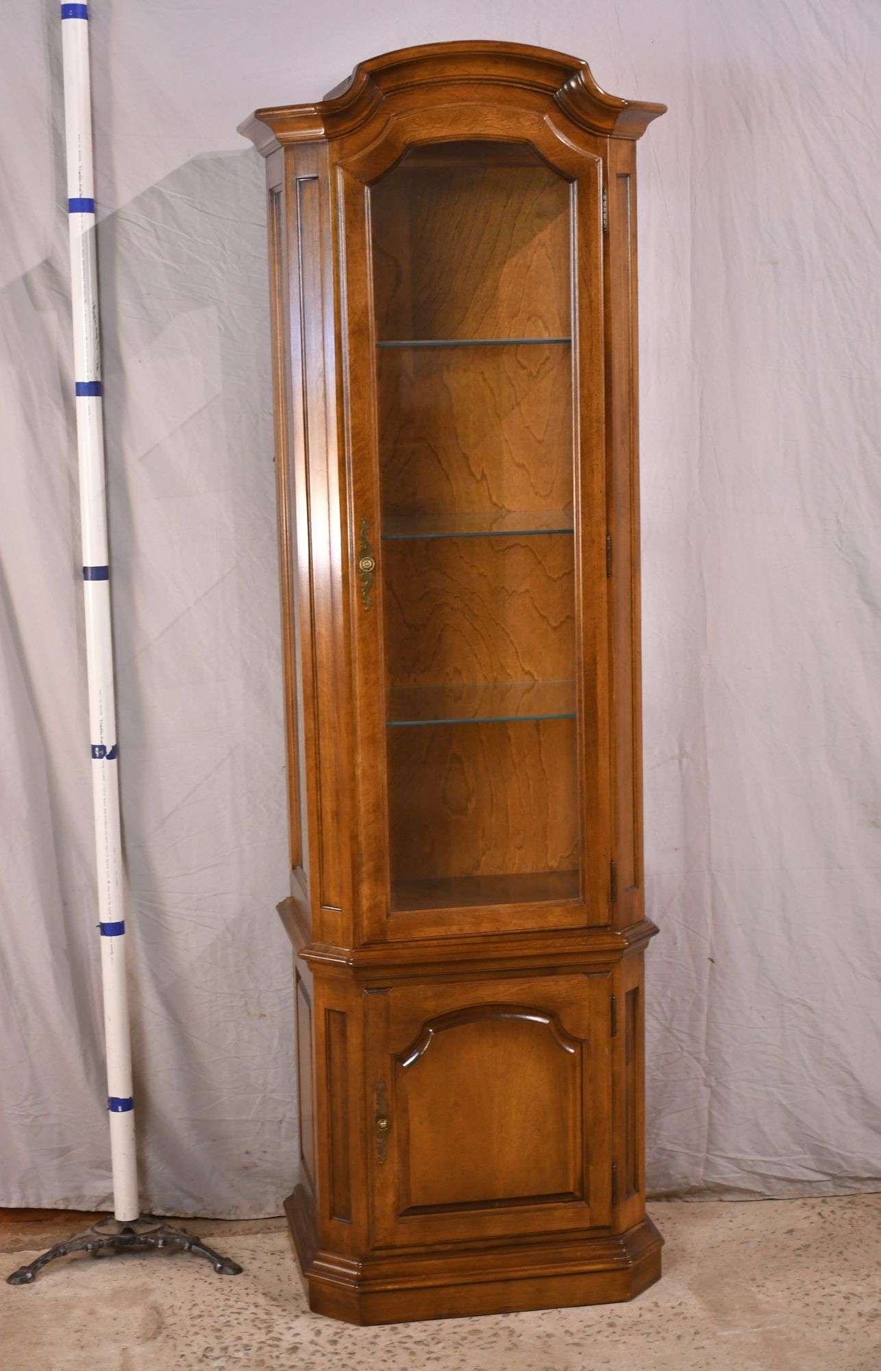 Tall narrow curio cabinet with lighted interior and glass shelves 74 9413 R.H. Lee Co. Auctioneers