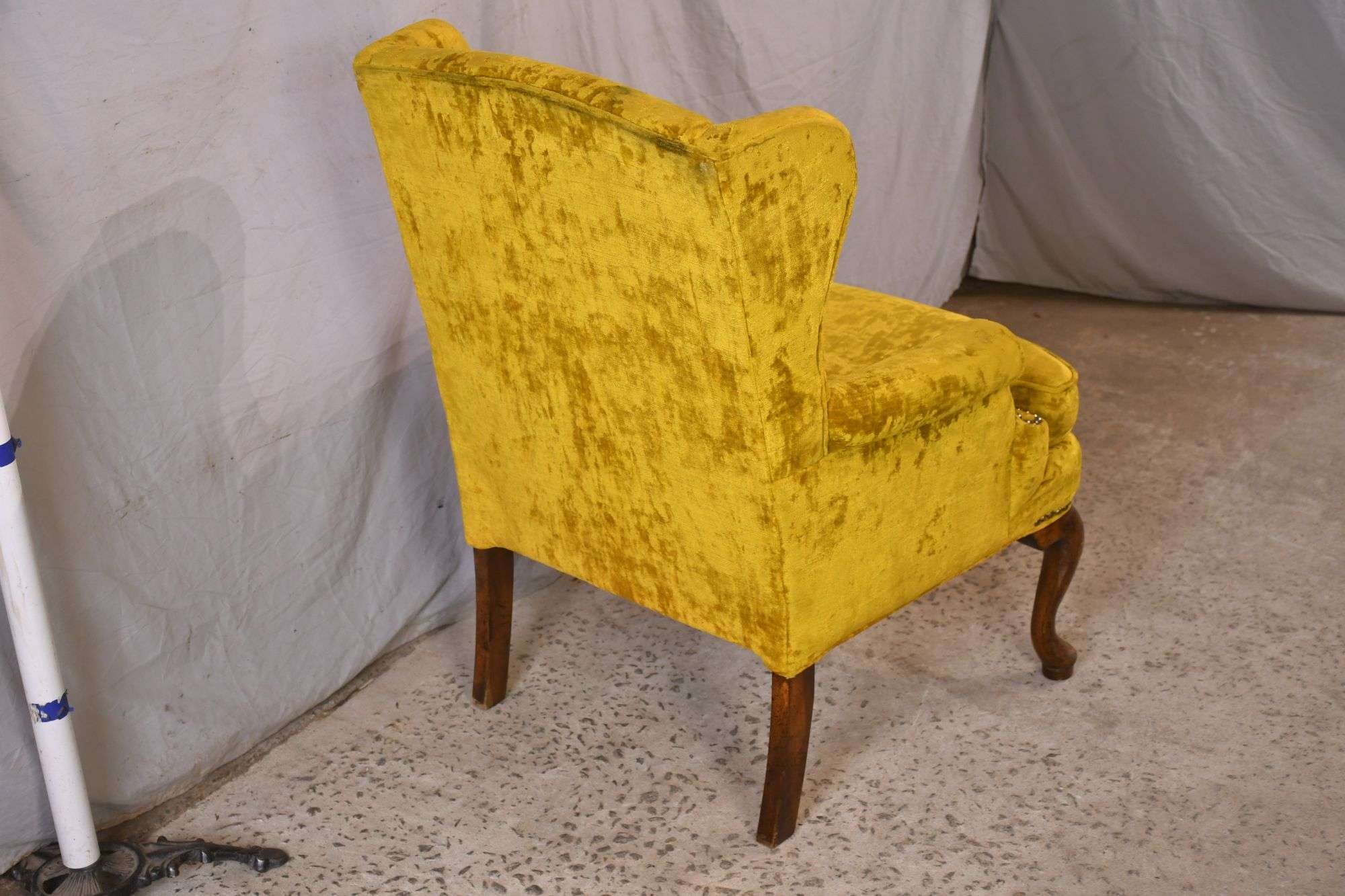 Yellow upholstered wingback armchair 55 10299A R.H. Lee Co. Auctioneers