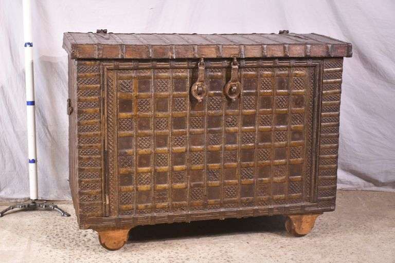 Large early distressed Oriental style lift top trunk with embossed ...