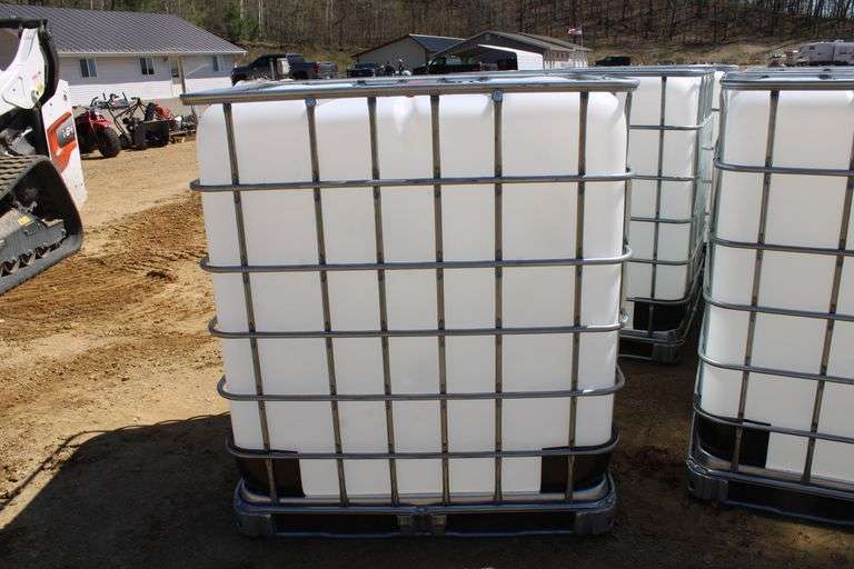 325 gal. poly tote in metal cage - Lee Real Estate & Auction Service