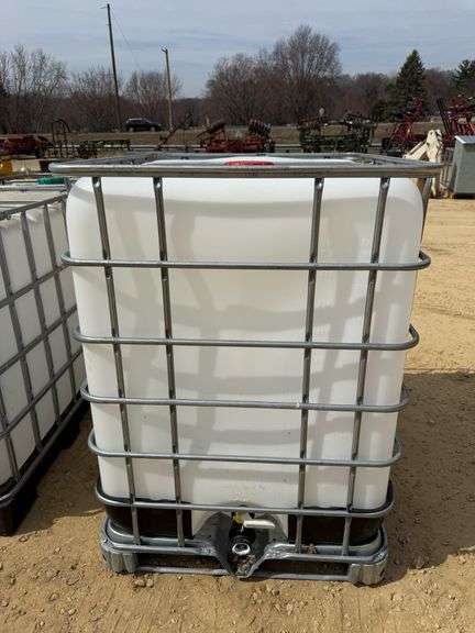 325 Gal Plastic Tote w/ Steel Cage - Lee Real Estate & Auction Service