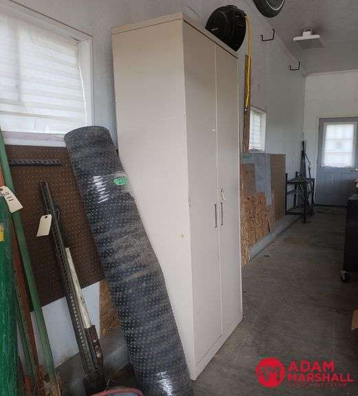 Upright metal cabinet with adjustable shelving. Locking doors with key ...